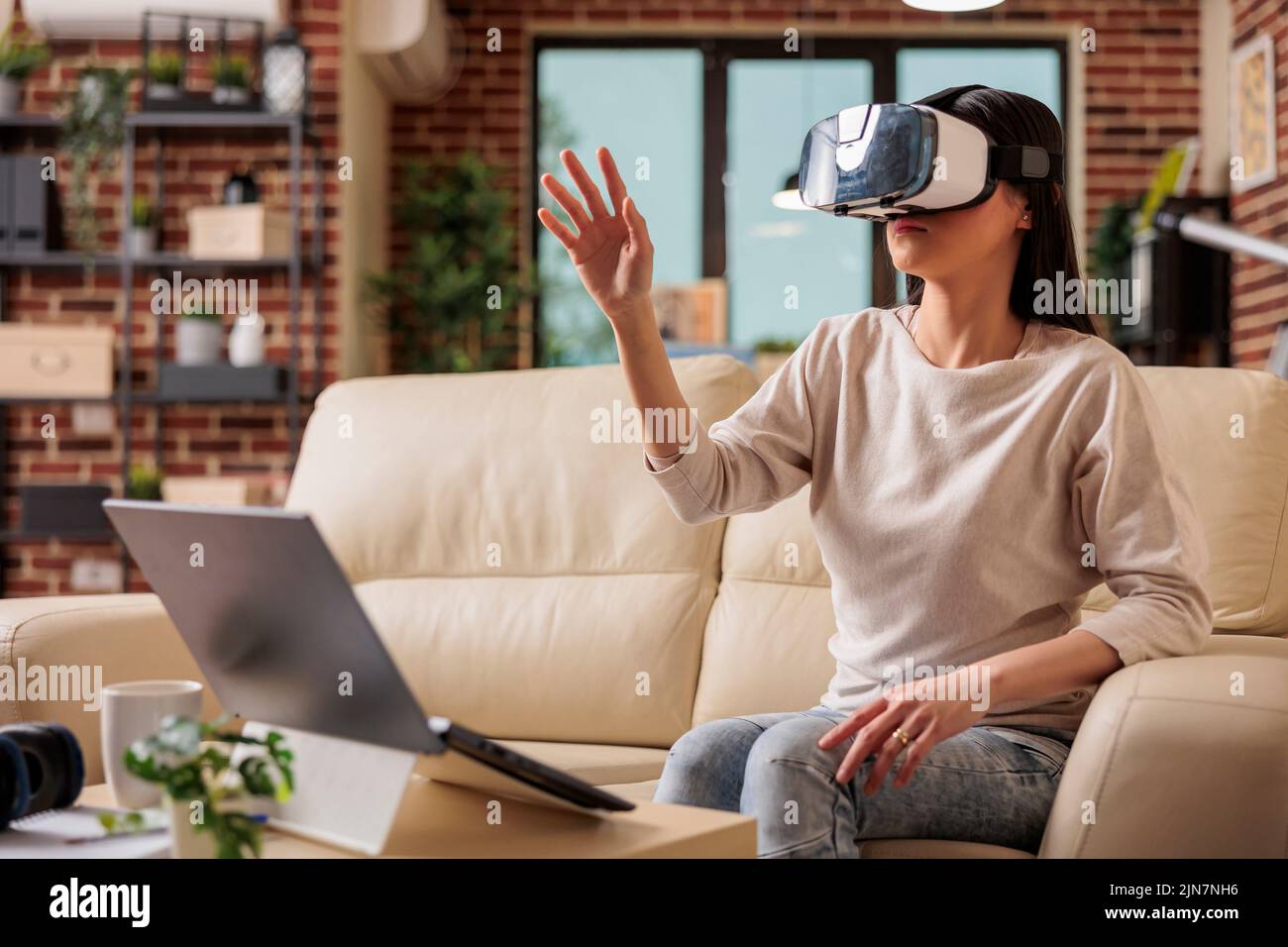 Happy asian woman enjoying wearing VR virtual reality headset, modern ...