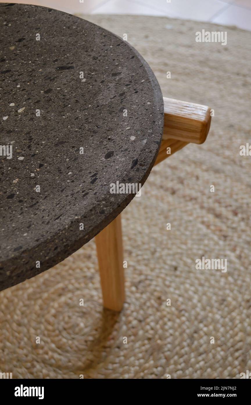 Designer small side table from a natural stone top, and wooden legs on ...