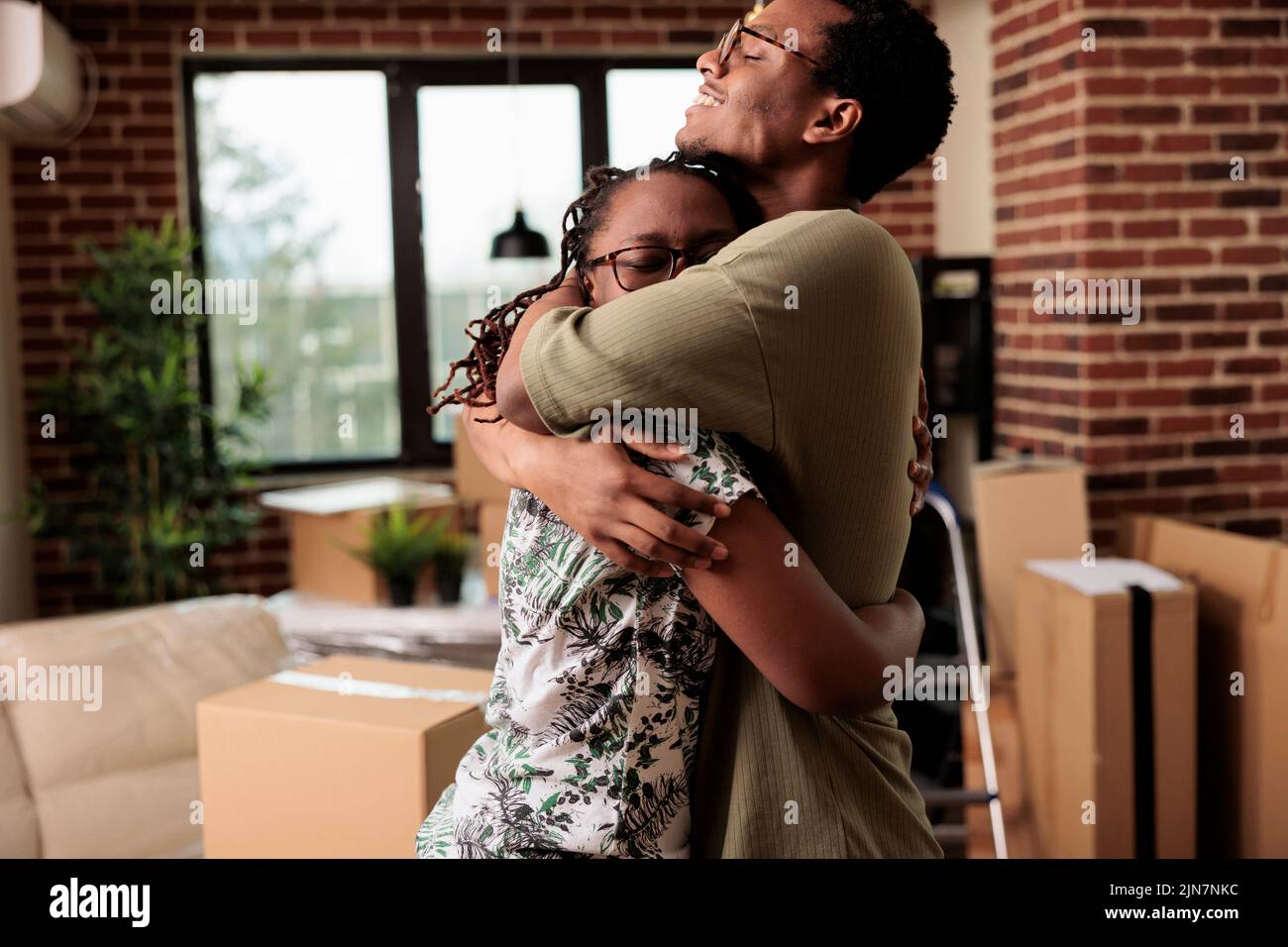 African american couple sharing hug and enjoying property relocation ...