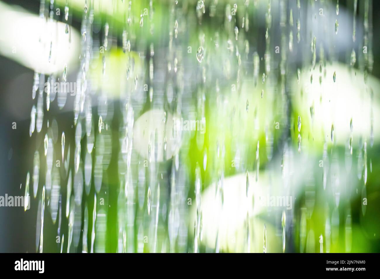 Blur abstract water drop movement by rain shower with close up shooting ...