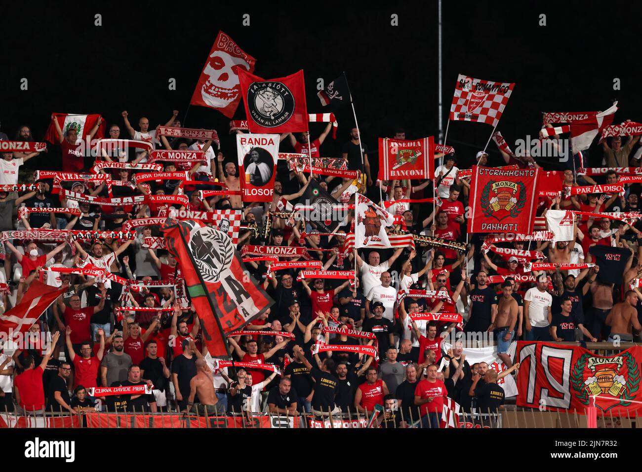 Monza, Italy, 7th August 2022. AC Monza fans hold up flag and scarves ...