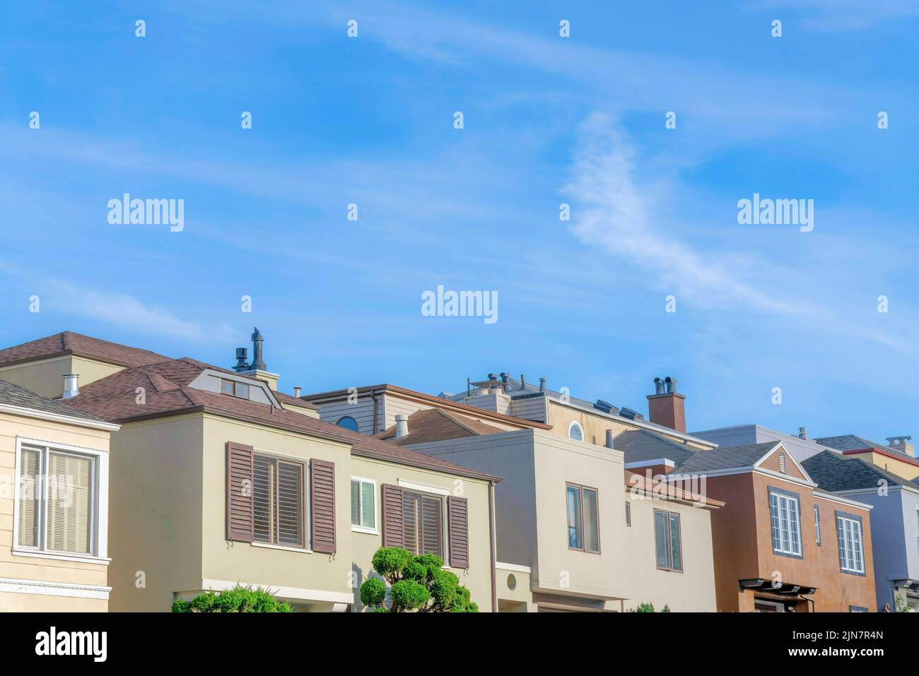 Suburbs houses with different architectural designs and chimneys with ...