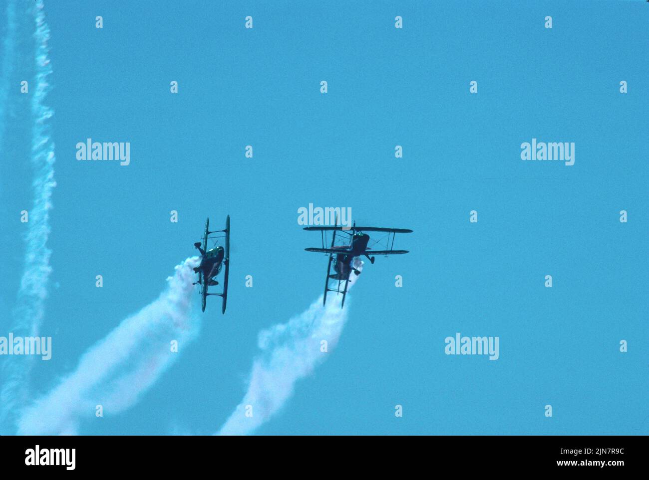 Three biplanes performing aerobatics Stock Photo - Alamy