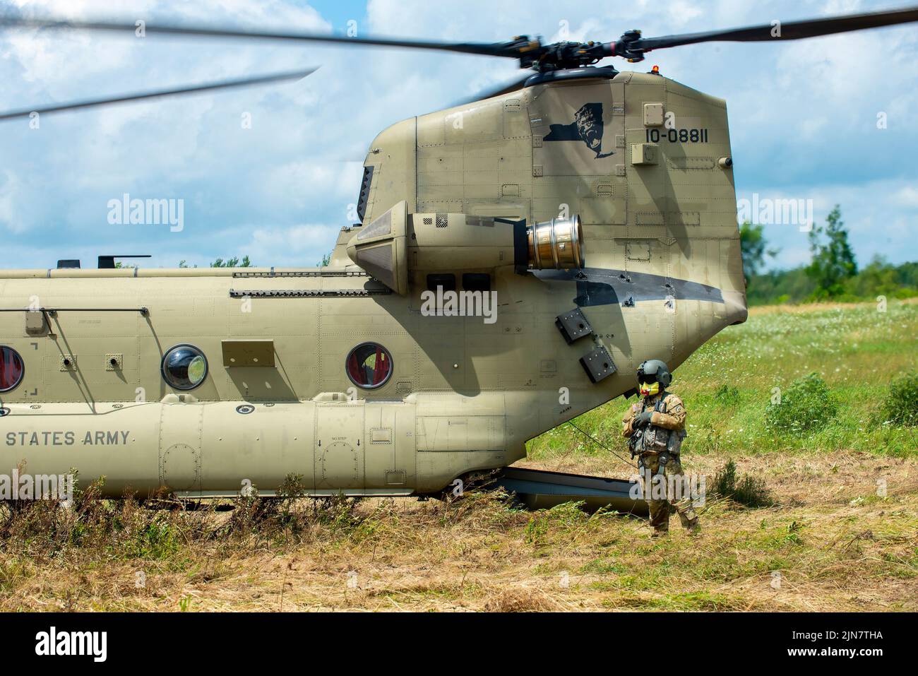A CH-47 Chinook crew member waits to board simulated patients for ...