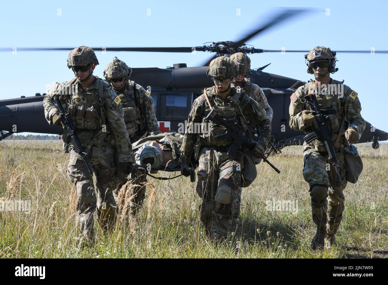 U.S. Soldiers assigned to V Corps team carry a manikin to a secure area ...