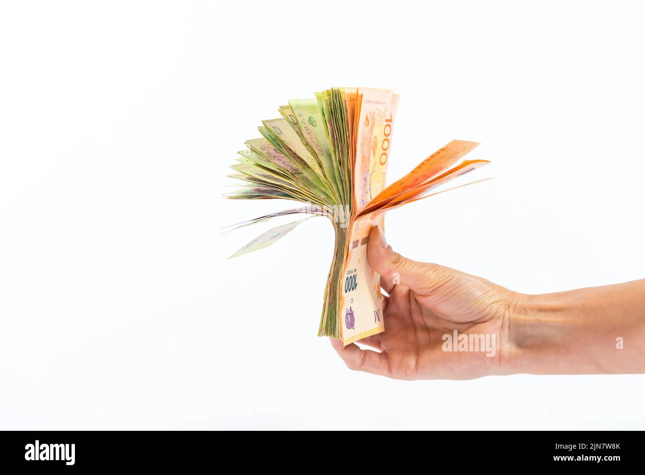 A money fan in a hand on isolated white background Stock Photo - Alamy