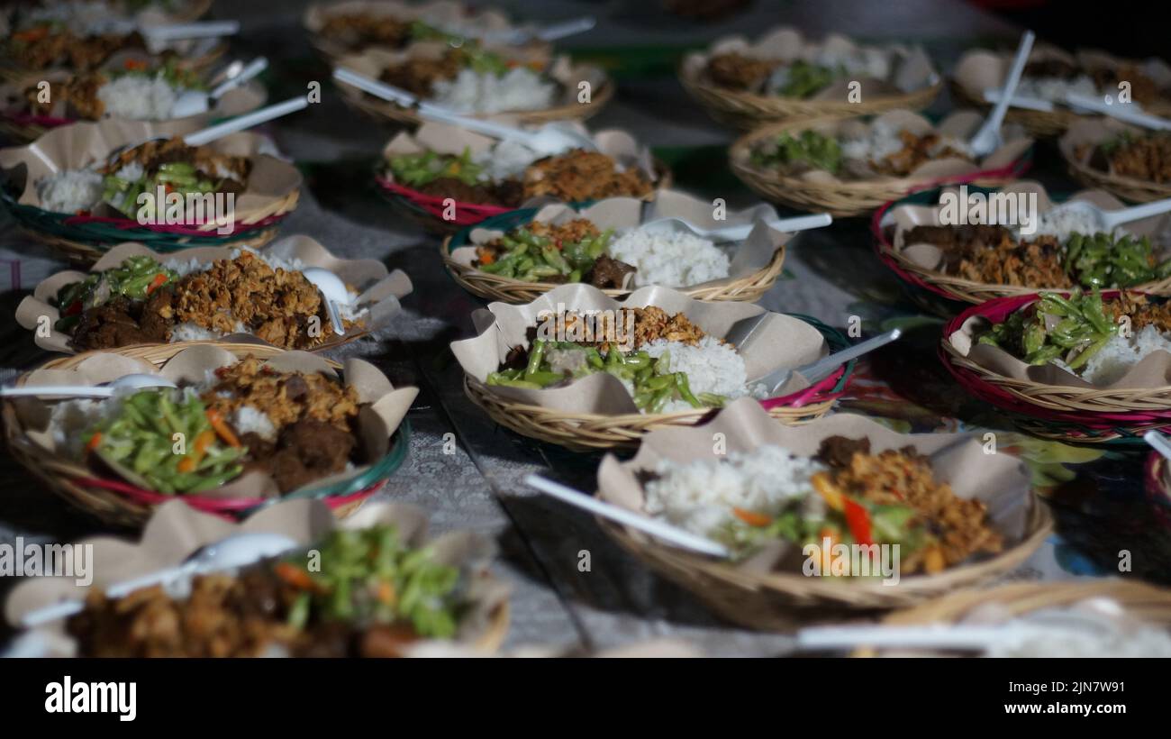 A dining table full of plates with the same meal, vegetable, rice and ...