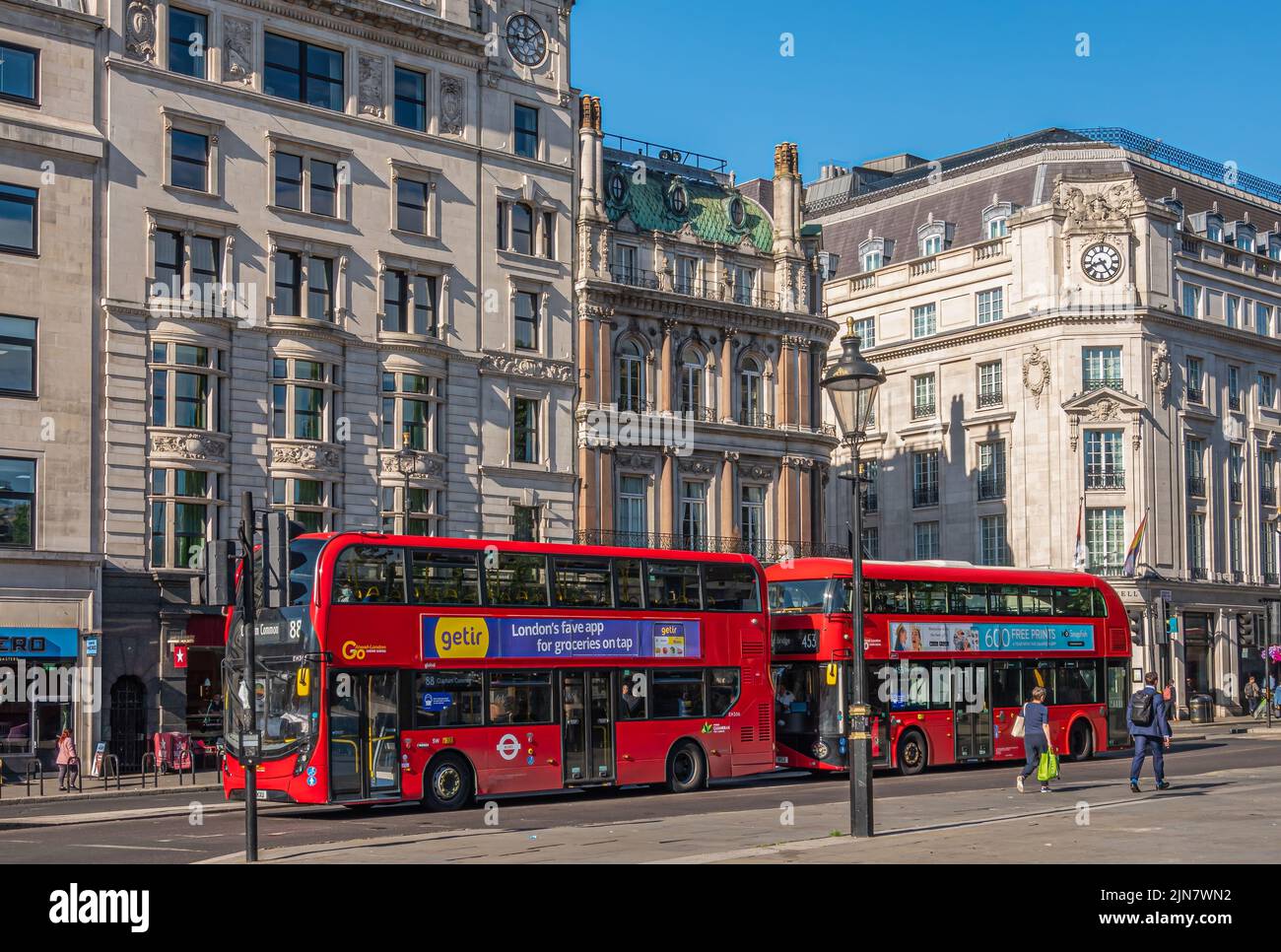 London, UK- July 4, 2022: Trafalgar Square. Double decker red buses on ...