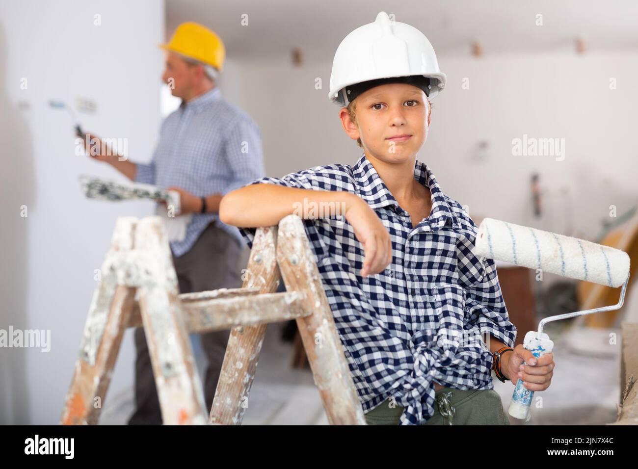 Boy posing with tools for home renovation Stock Photo - Alamy