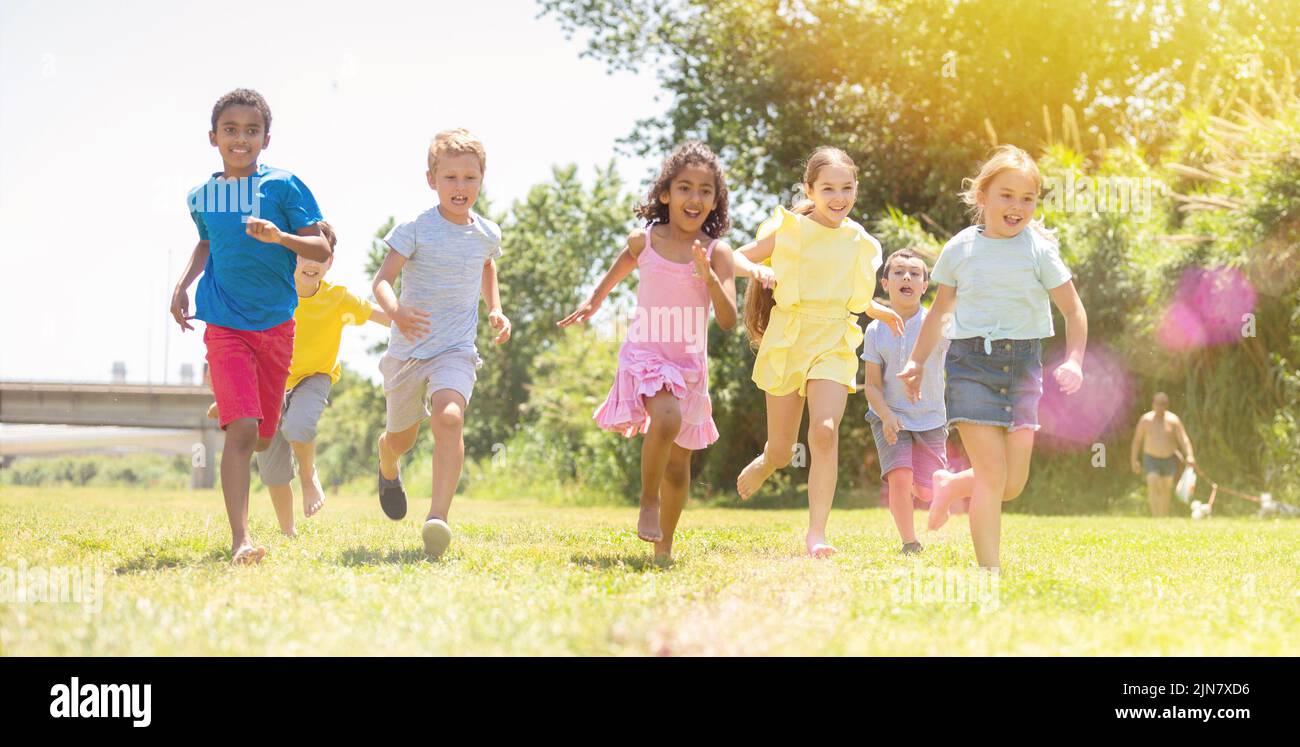 Happy kids running in race in the street and laughing Stock Photo - Alamy
