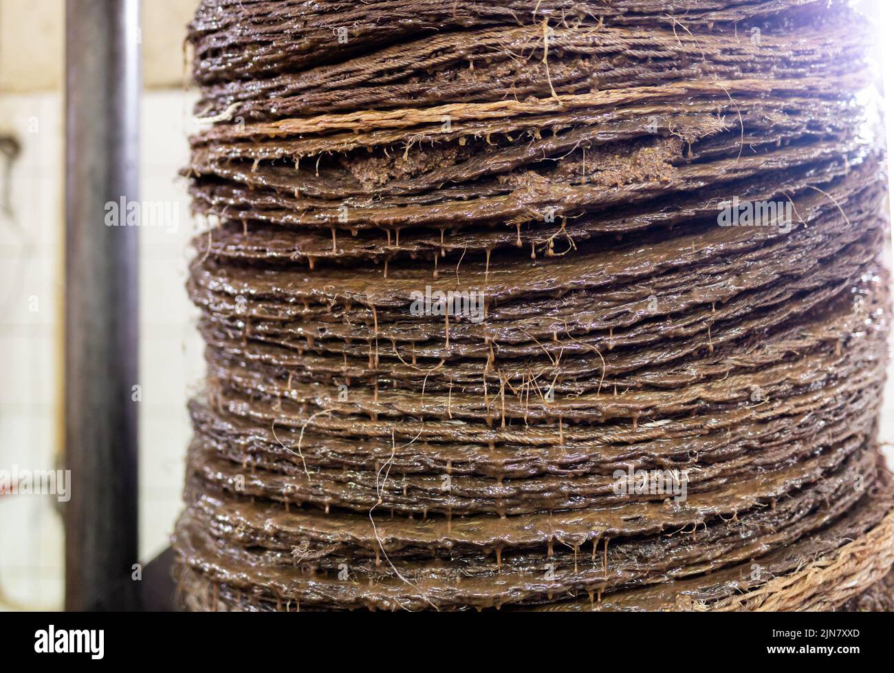Fiber mats with olive paste during pressing Stock Photo - Alamy