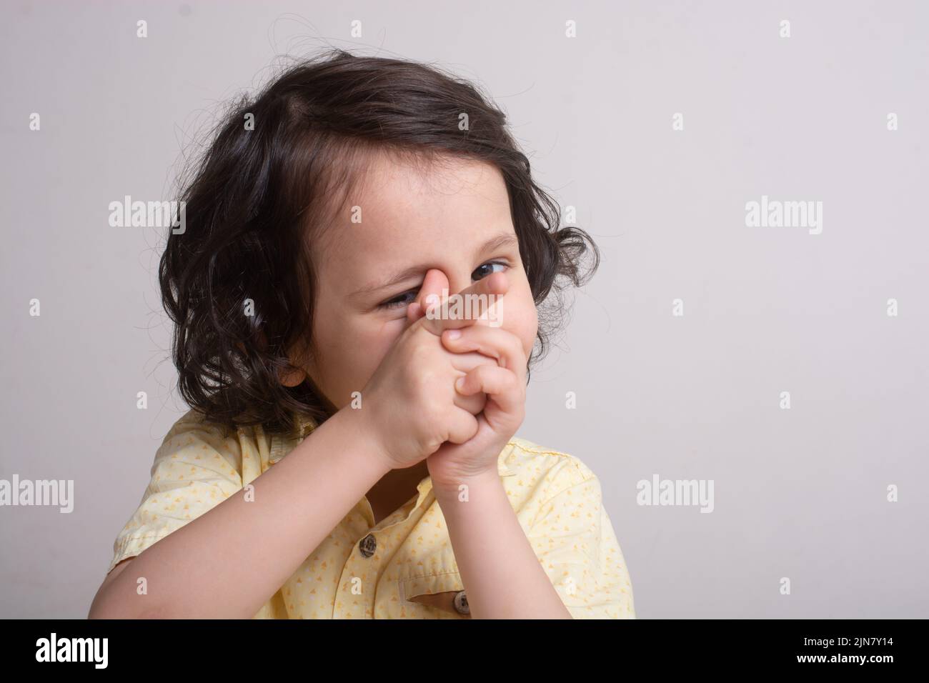 Little cute boy trying to make a serious face Stock Photo - Alamy