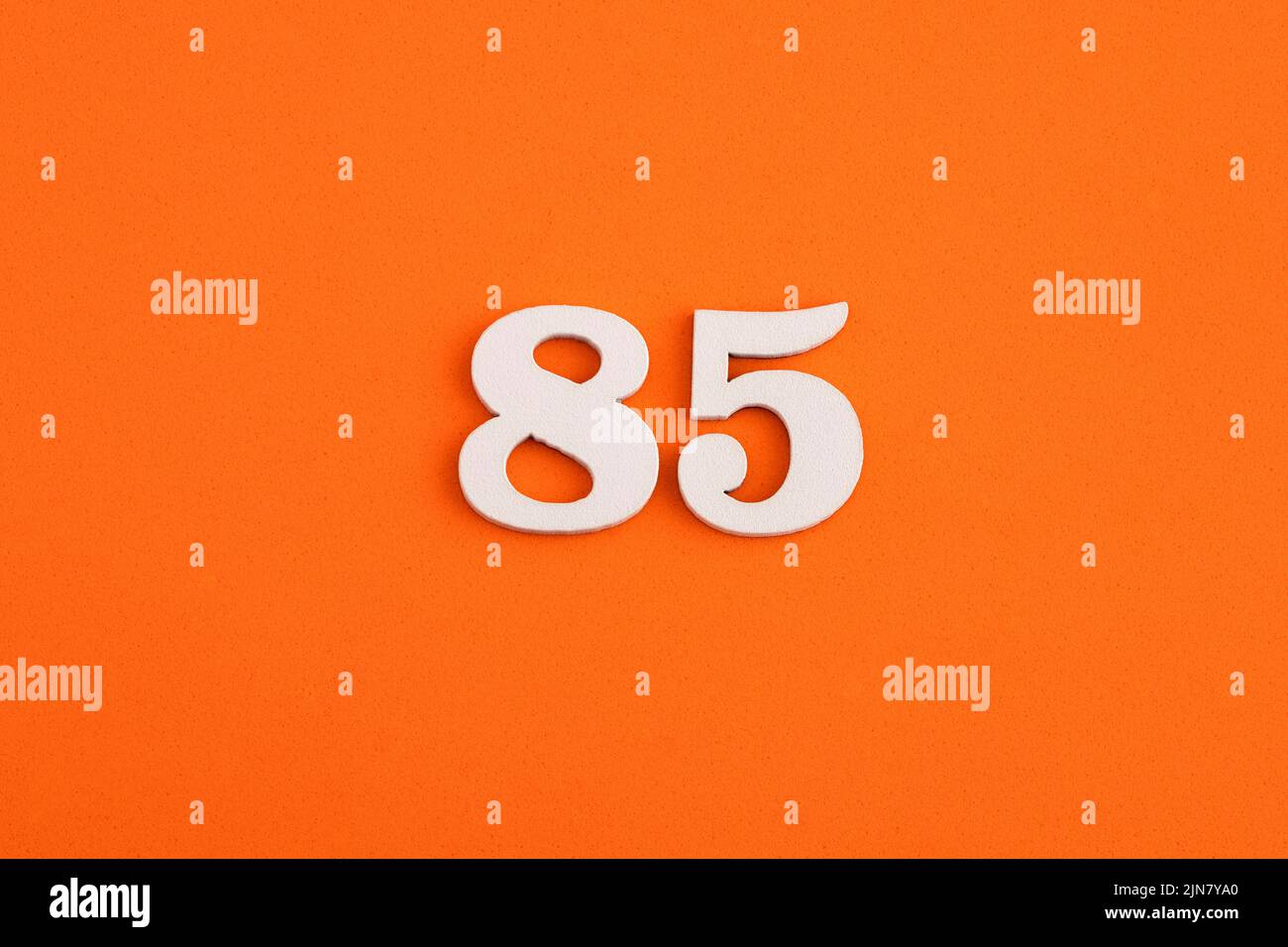 Number 85 - On orange foam rubber background Stock Photo - Alamy