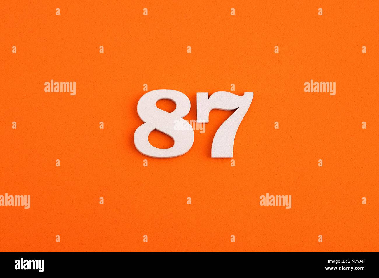 Number 87 - On orange foam rubber background Stock Photo - Alamy