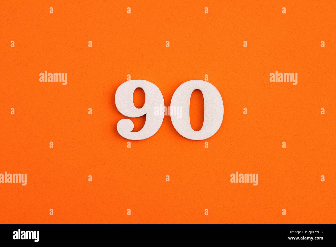 White wooden number 90 on eva rubber orange background Stock Photo - Alamy