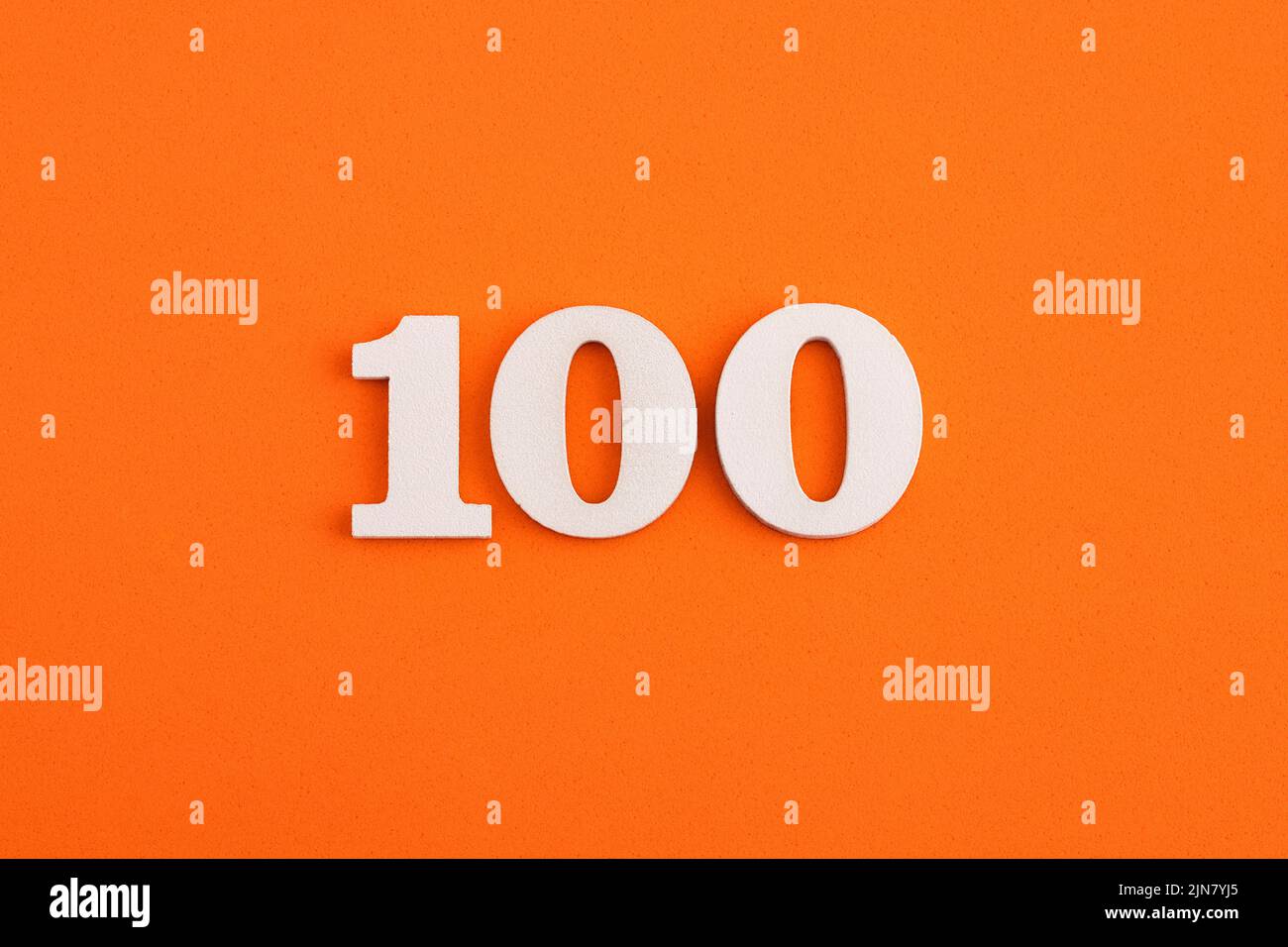 White wooden number 100 on eva rubber orange background Stock Photo - Alamy