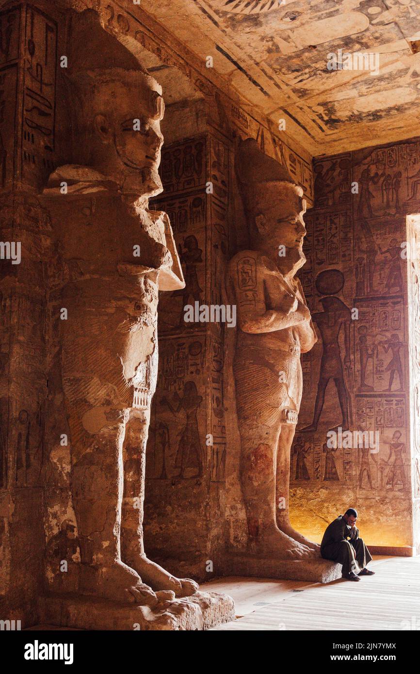 The interior of the The Great Temple at Abu Simbel with a person ...