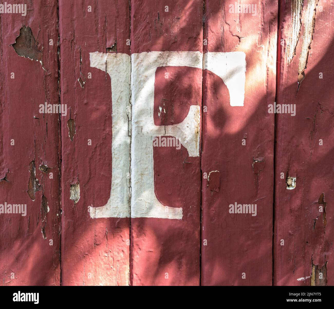 Letter 'F' on red painted railroad car siding Stock Photo - Alamy