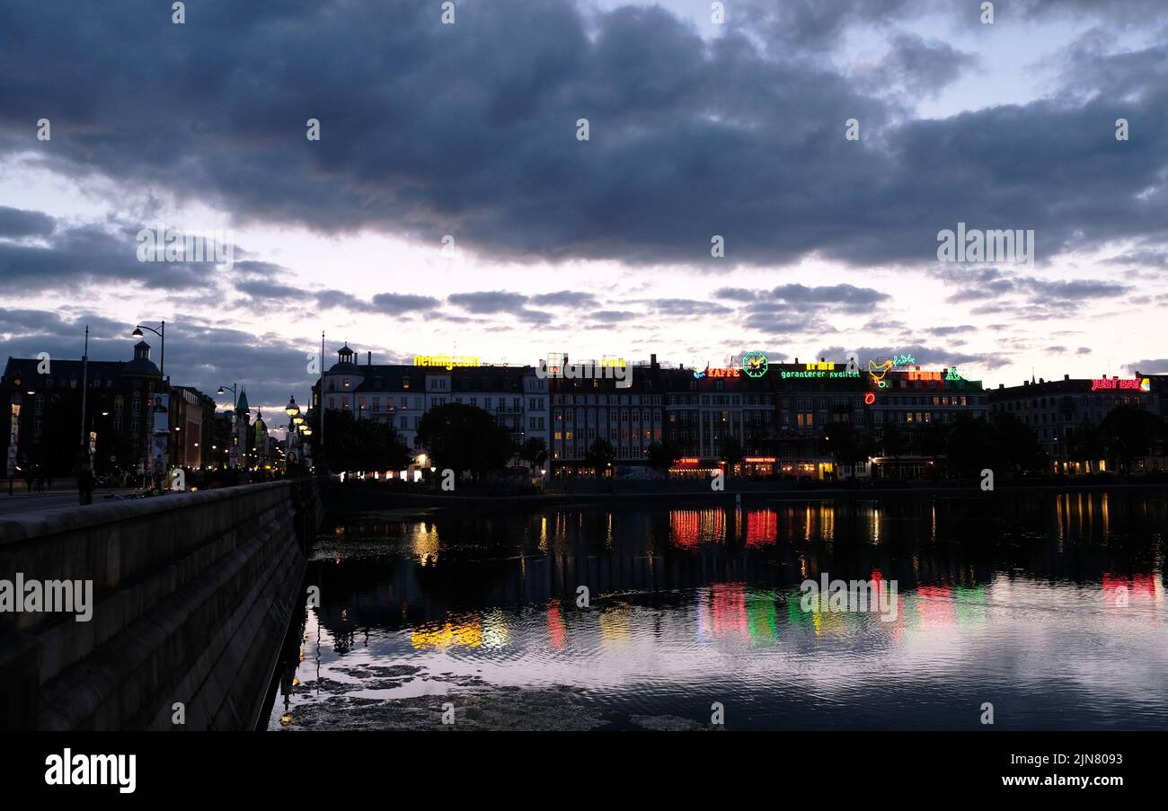 Copenhagen, capital city of Denmark at night, with the neon reflecting ...