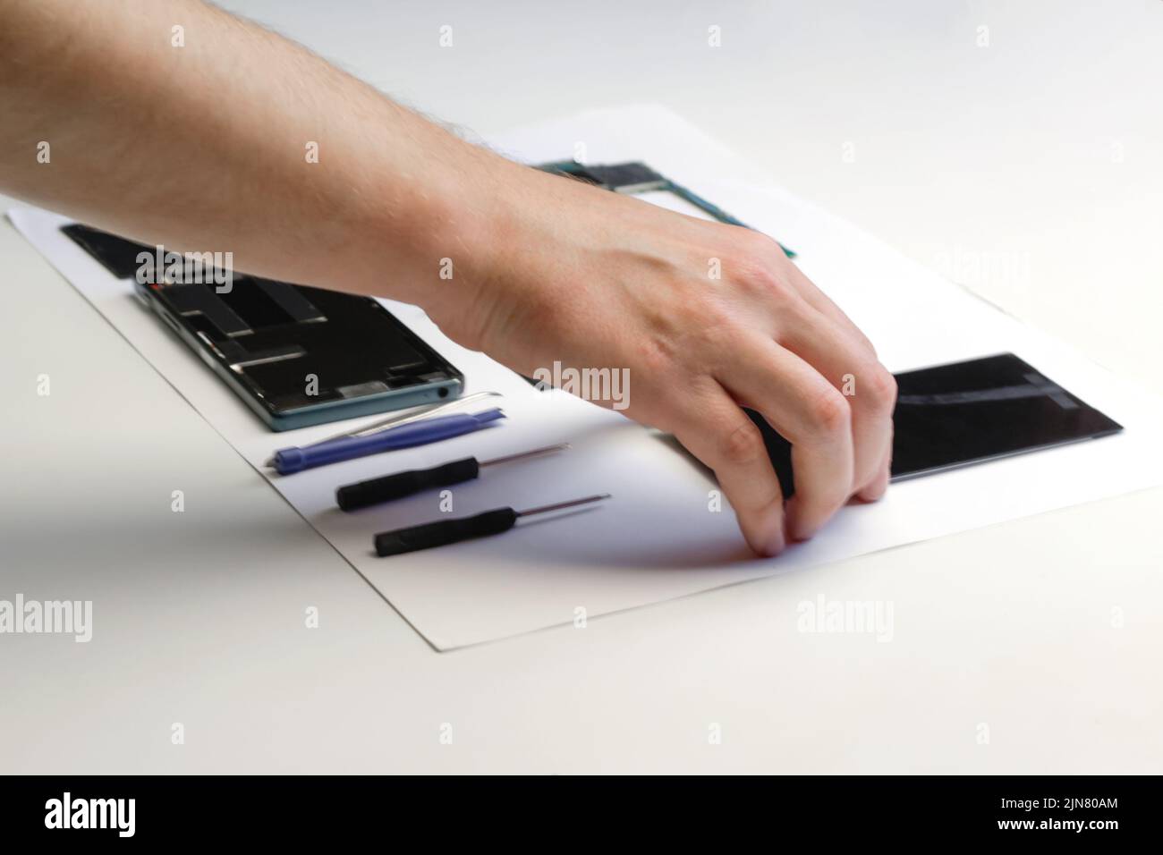 Defocus electronic repair. Technician repairing electronic circuit board with soldering iron ...