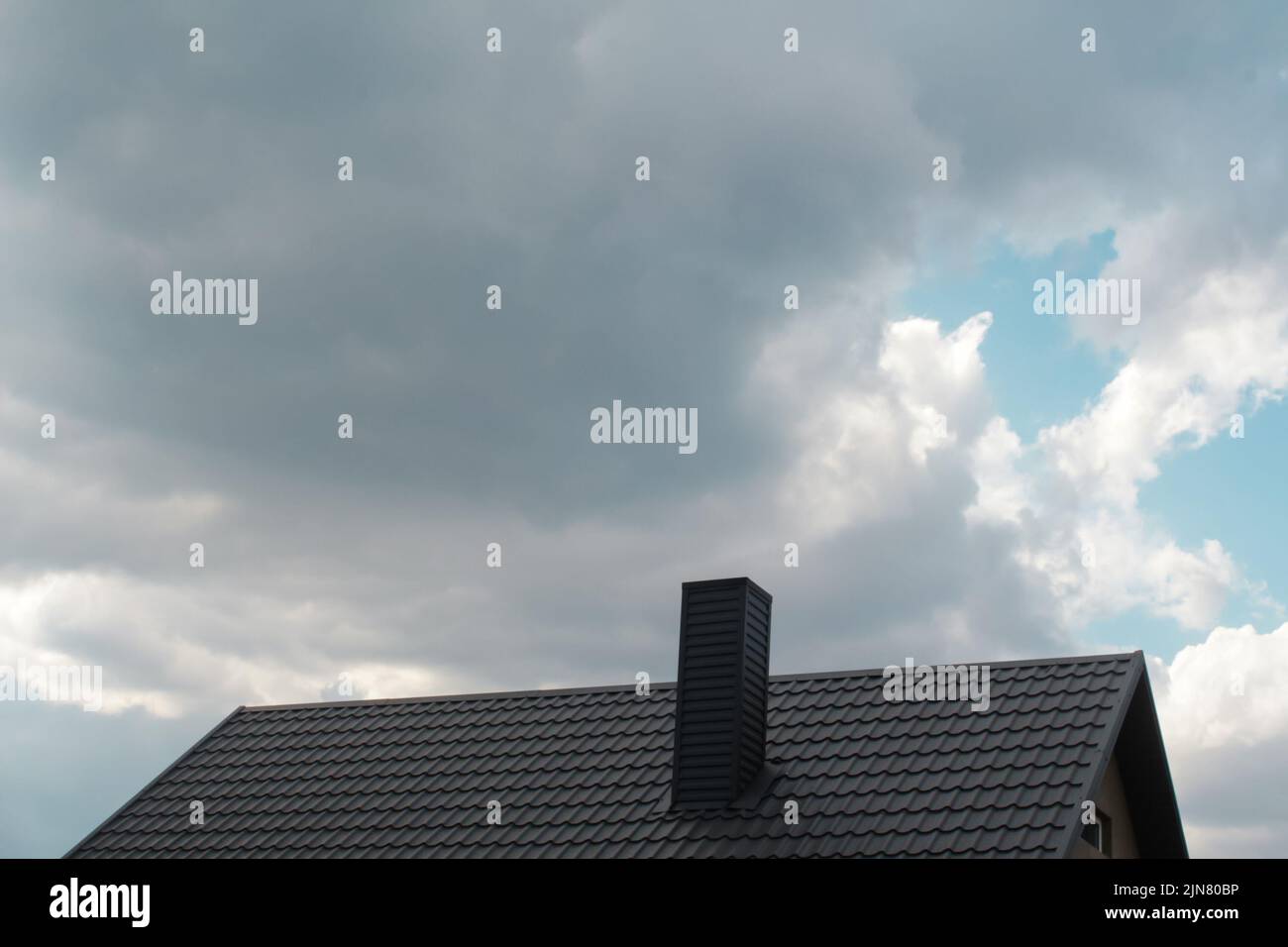 Defocus steel roof on dark sky background. Dark rain clouds above the ...