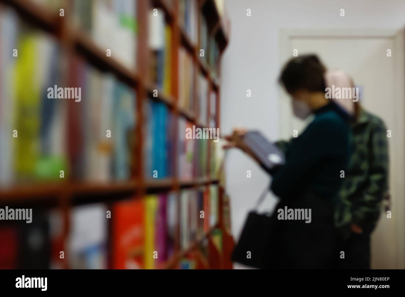 Defocus reading concept. Vintage tone of woman selecting book from a ...