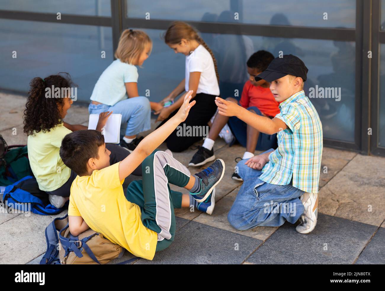 Group of children playing near school Stock Photo - Alamy