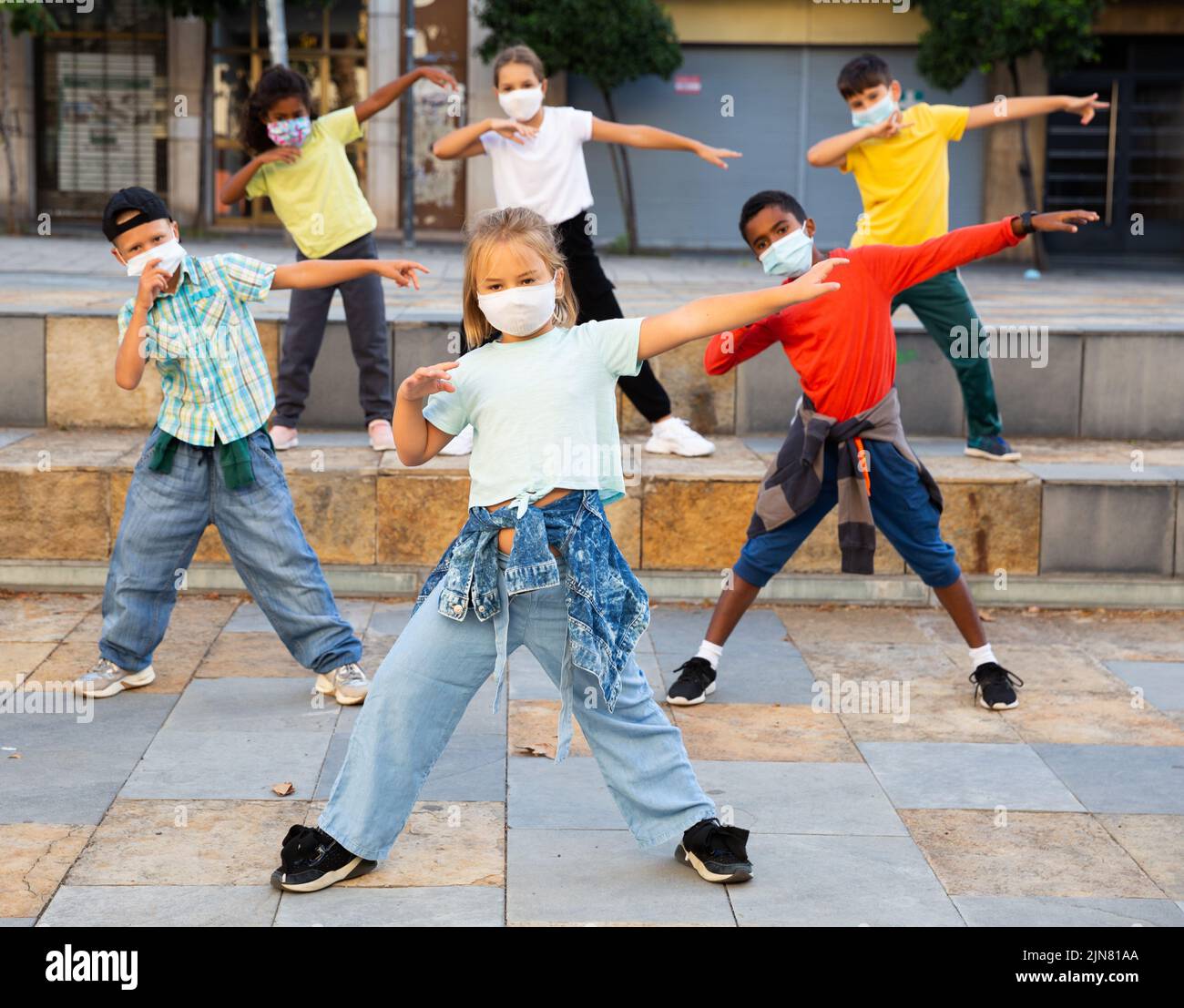 Kids in masks dancing on street Stock Photo - Alamy