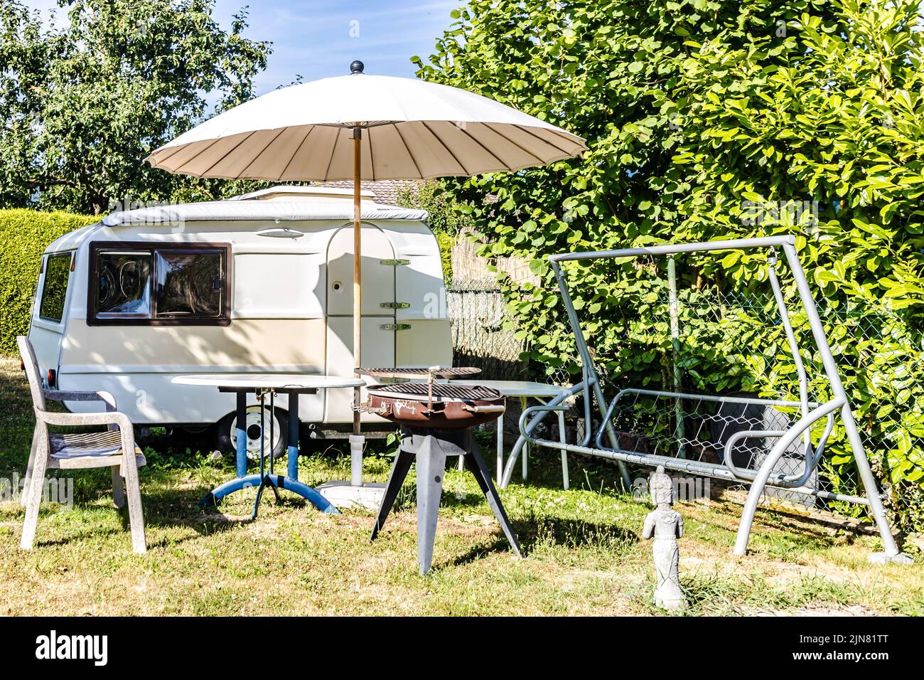 Seating next to a caravan with a parasol on a sunny day Stock Photo - Alamy