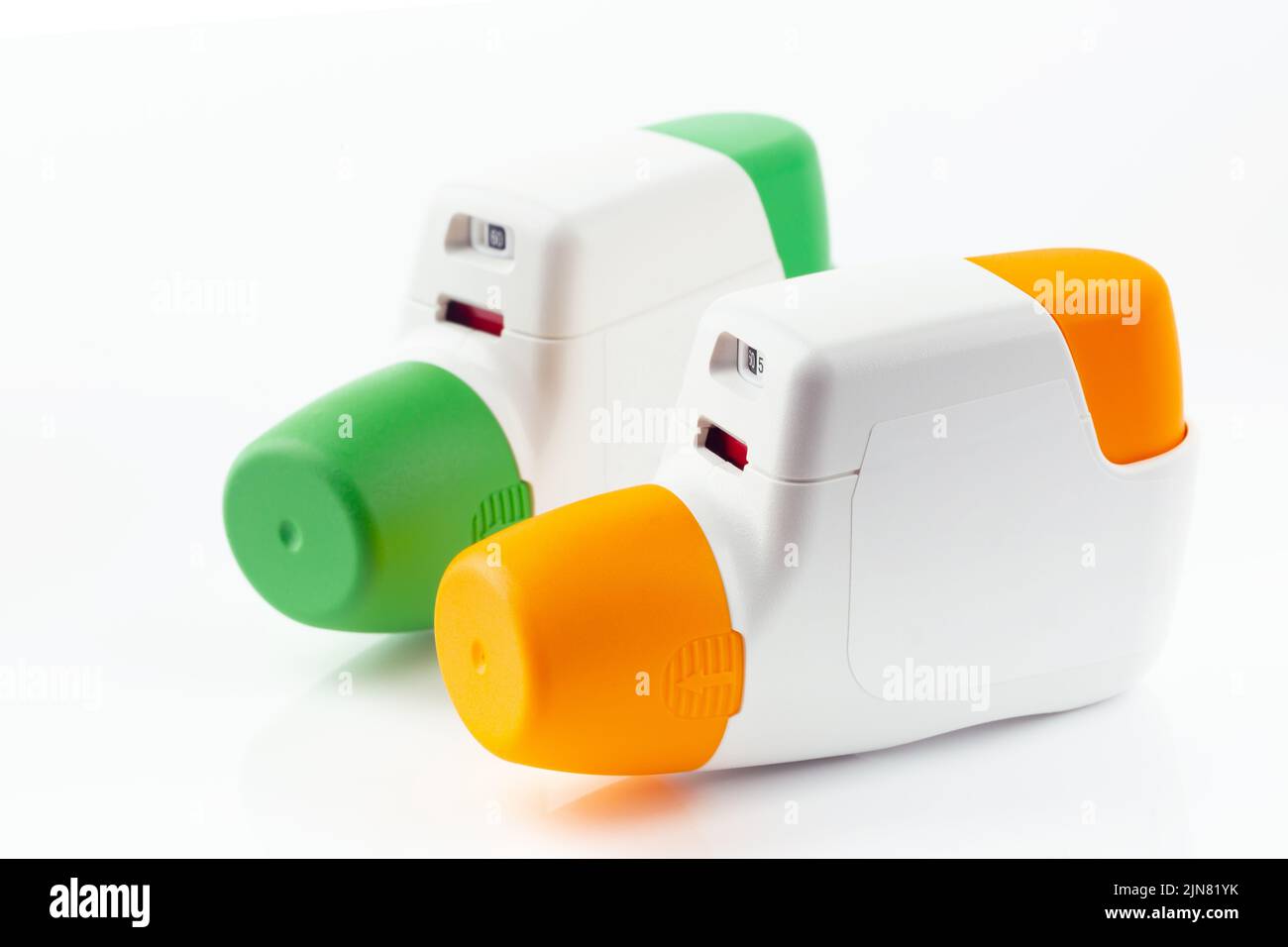 Two Metered Dose Inhaler isolated over white background Stock Photo - Alamy