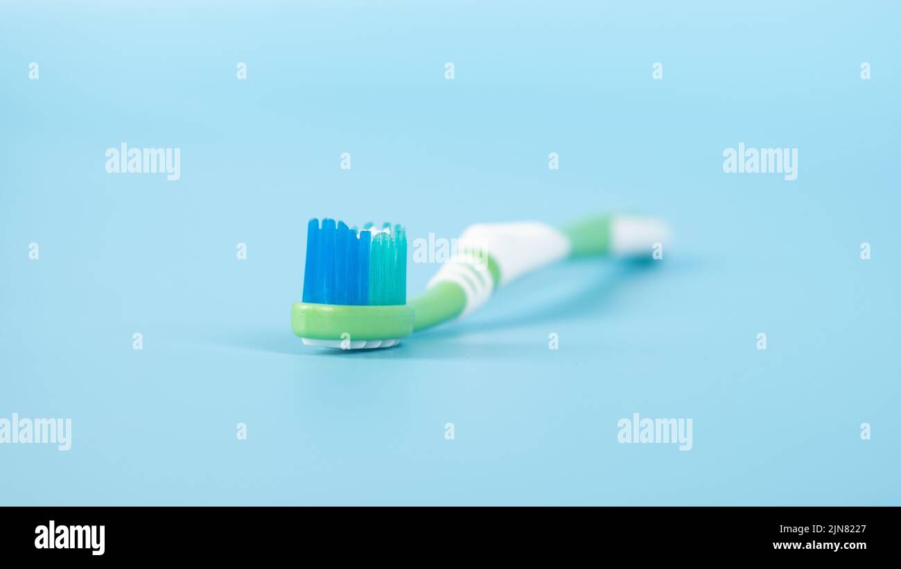 toothpaste and brush on a blue background, oral and dental care concept ...