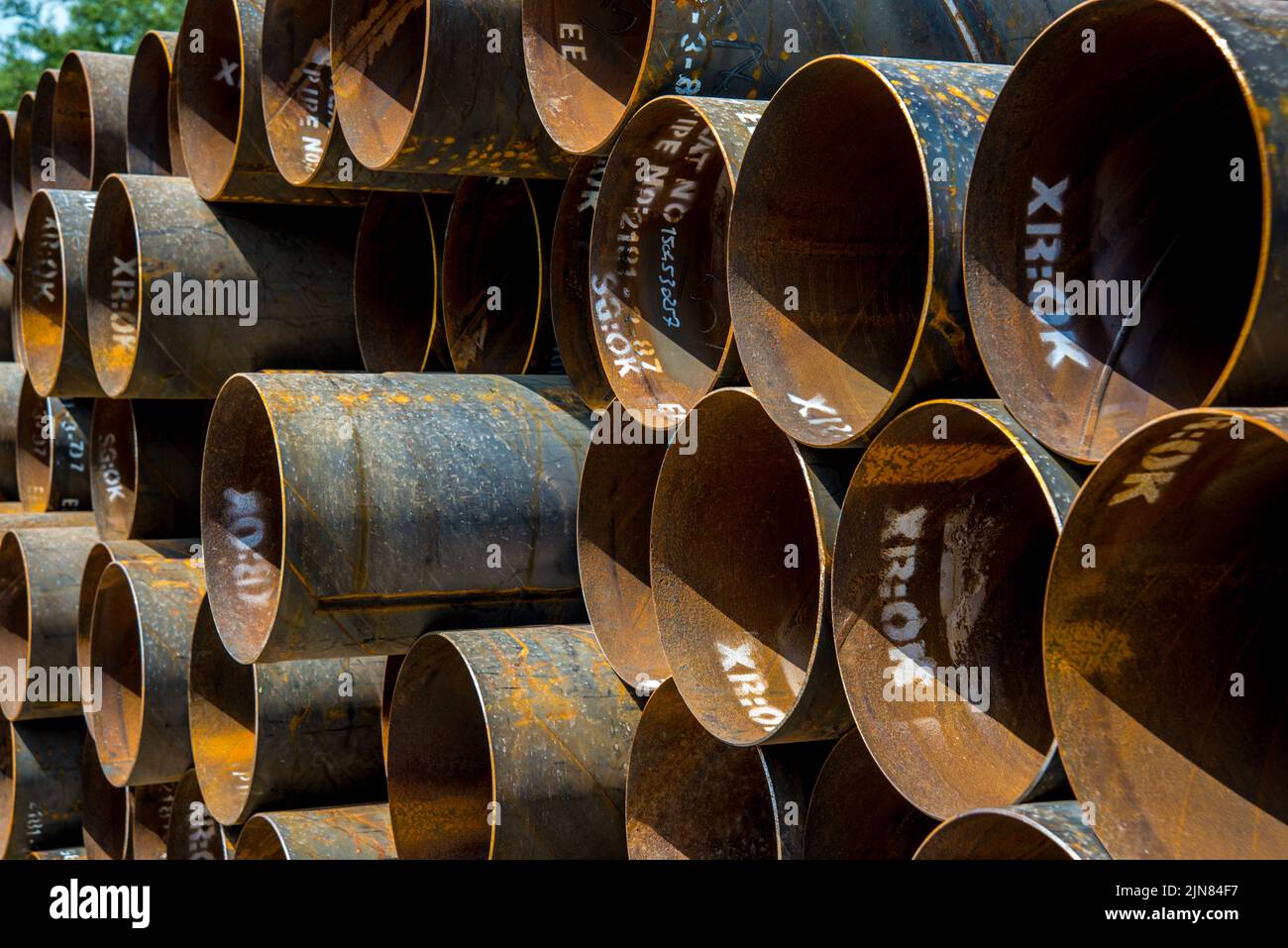 Stack of large diameter metal pipes Stock Photo - Alamy