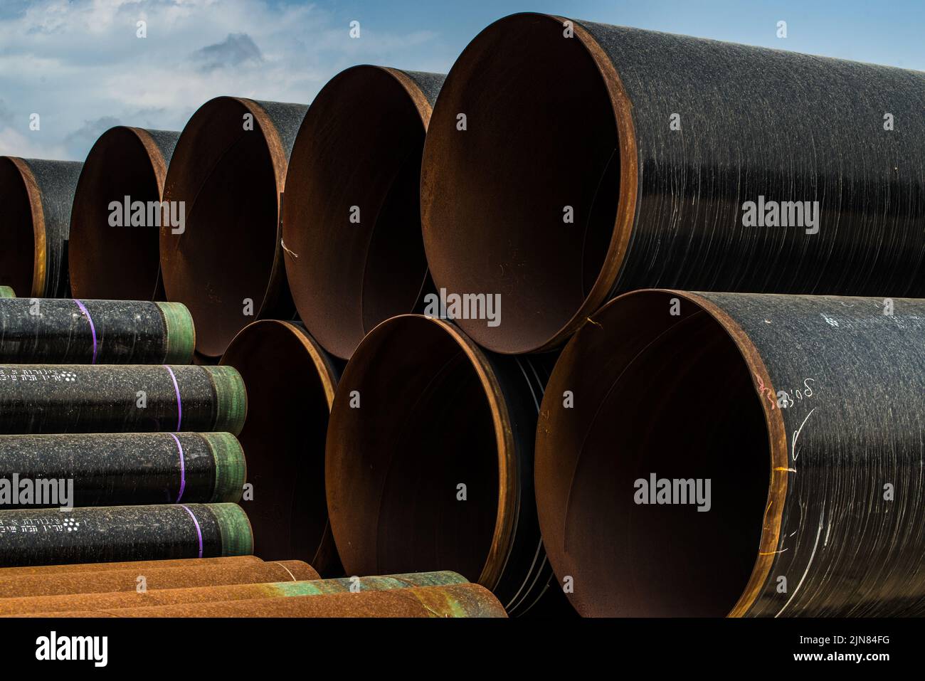 Stack of large diameter metal pipes Stock Photo - Alamy