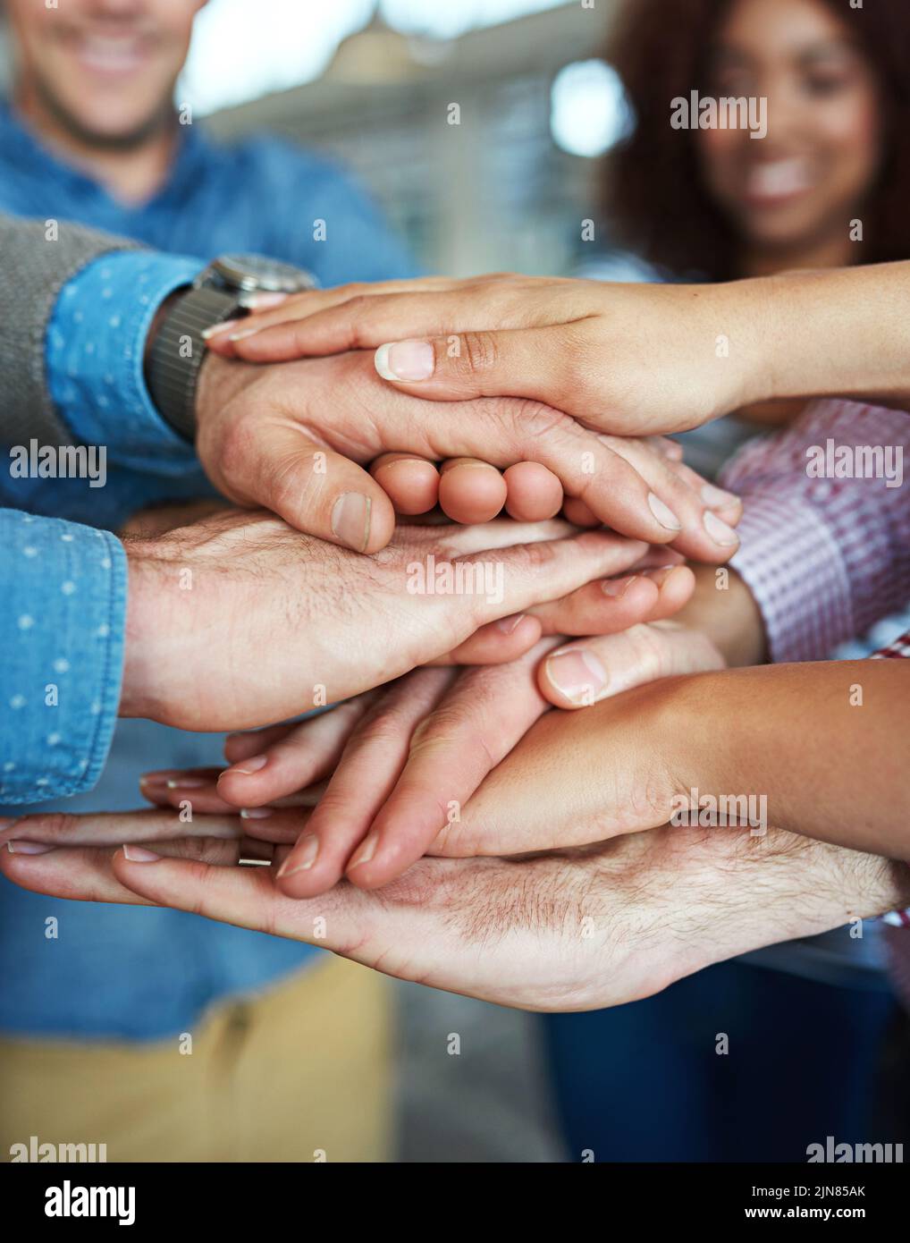 Celebrating and winning business people pile of hands in victory and ...