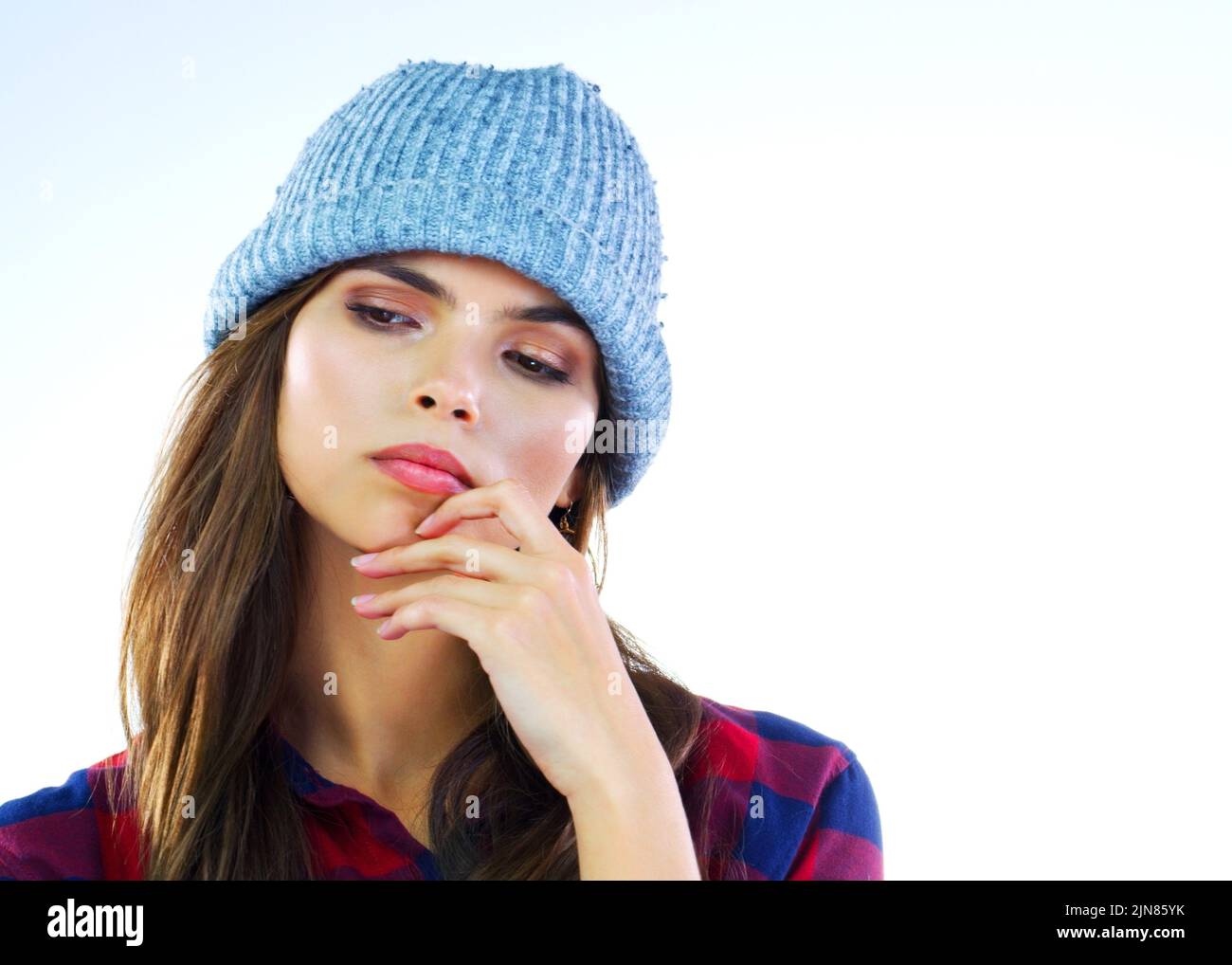 Im not so sure. a young woman posing against a white background Stock ...