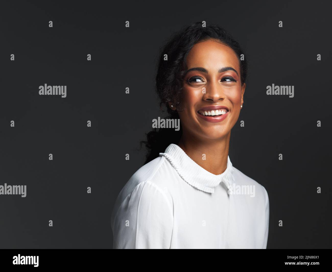 The most beautiful woman is the one smiling. Studio shot of an ...