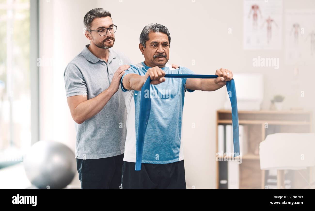 Growing stronger with every stretch. a senior man exercising with a ...