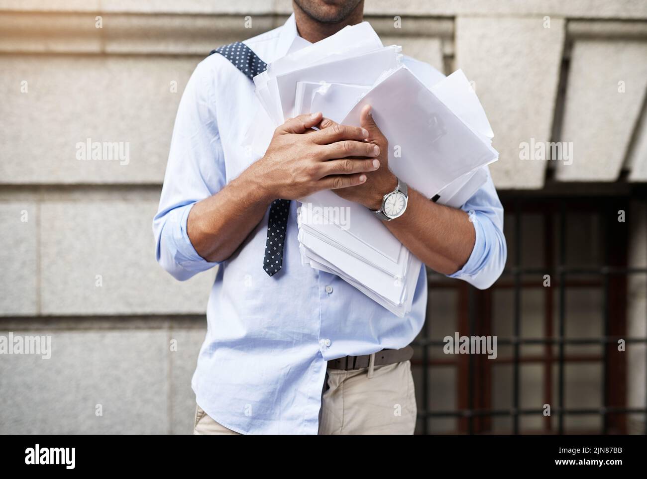 Its going to be a long day. an unrecognizable young man holding a heap ...