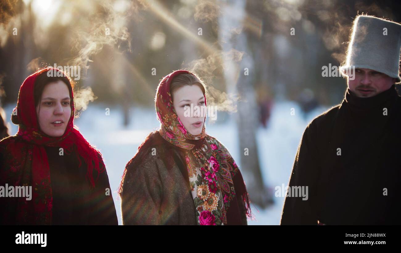 Russian folklore - young russian people standing outdoors at winter ...