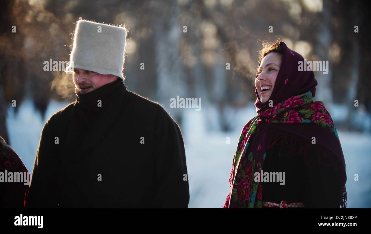 Russian folklore - russian man and woman standing outdoors at winter ...