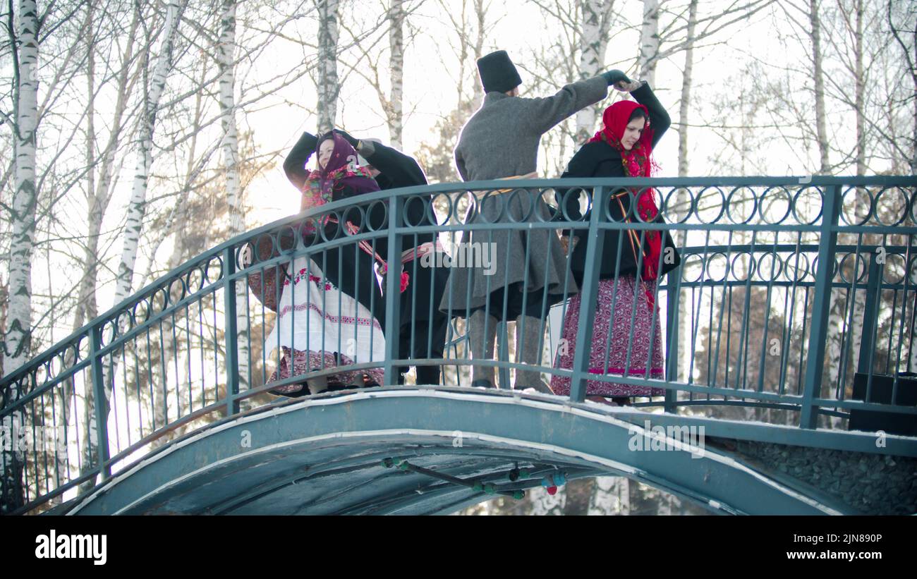 Russian folklore - men and women are dancing on the bridge Stock Photo ...