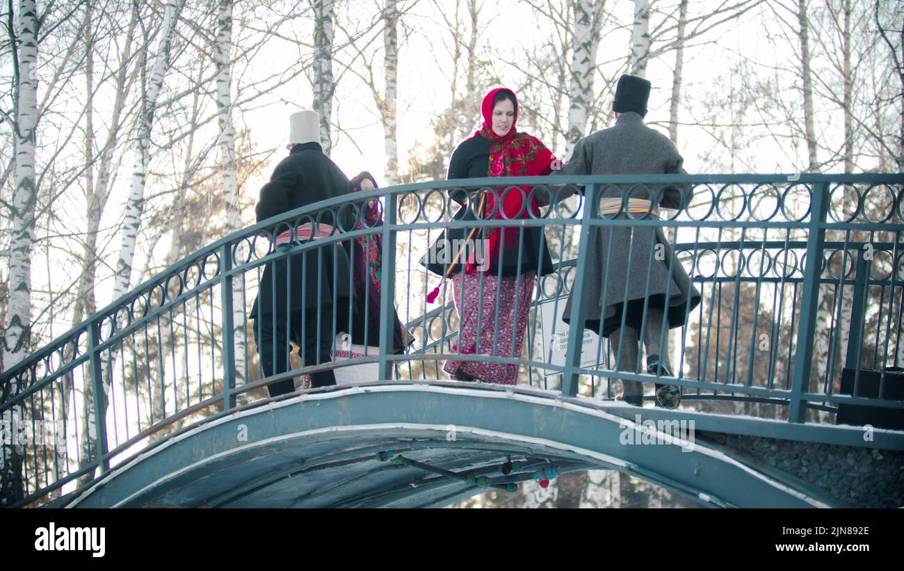 Russian folk - woman in a bright scarf is riding on a swing and ...
