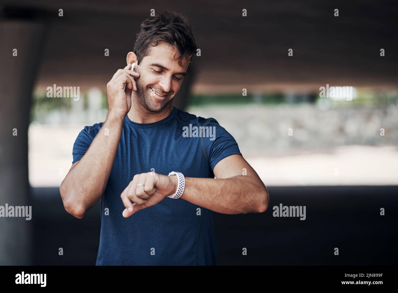 Lets get ready for another heart-pumping run. a sporty young man ...