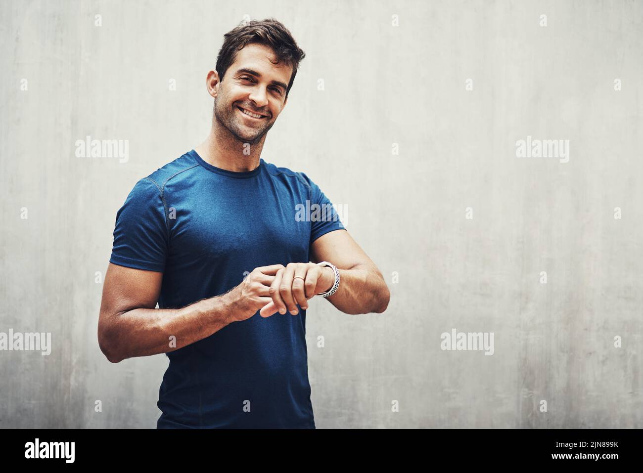 Always beating my best. Portrait of a sporty young man checking his ...