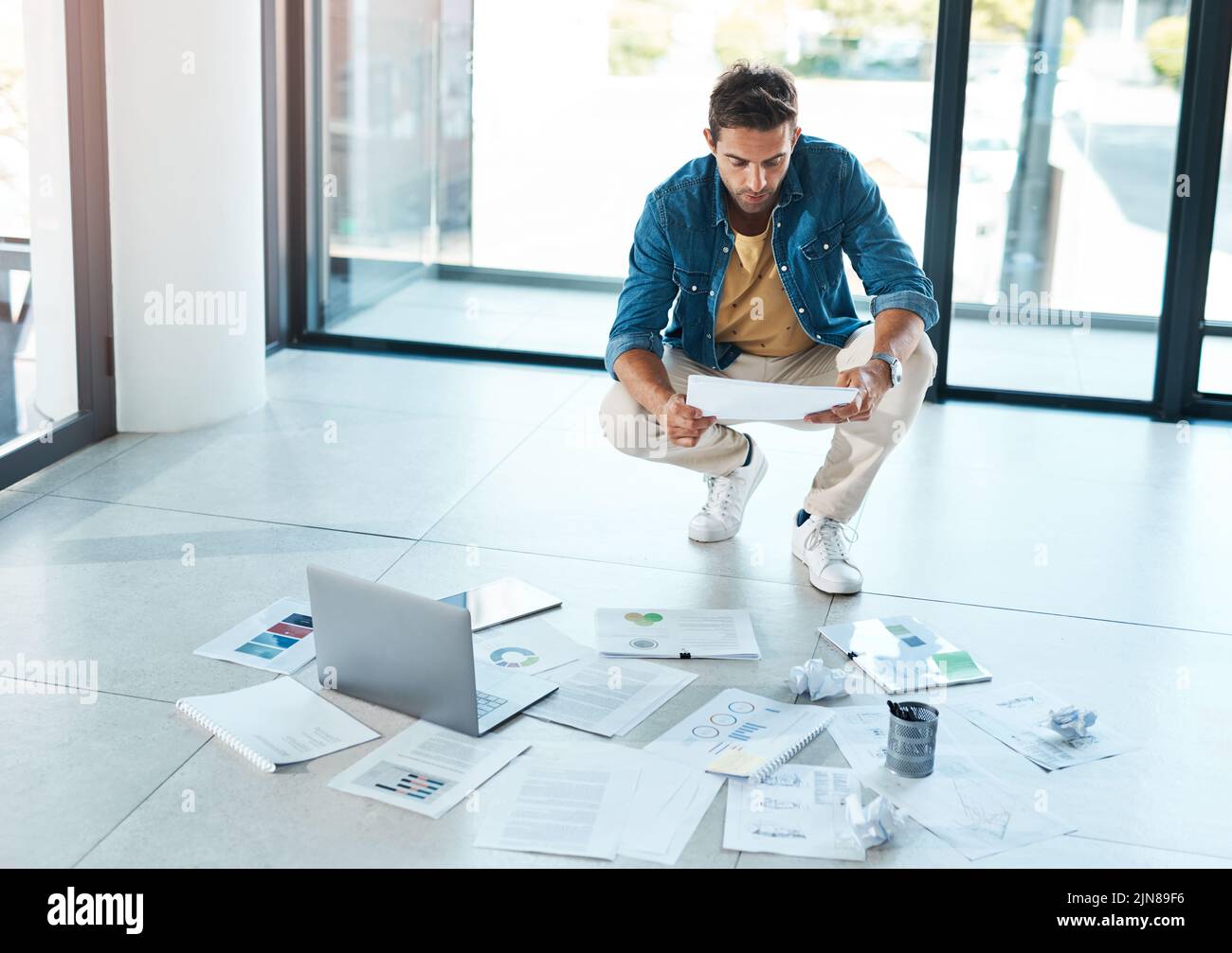He has a bunch of new data to review. a young businessman brainstorming ...