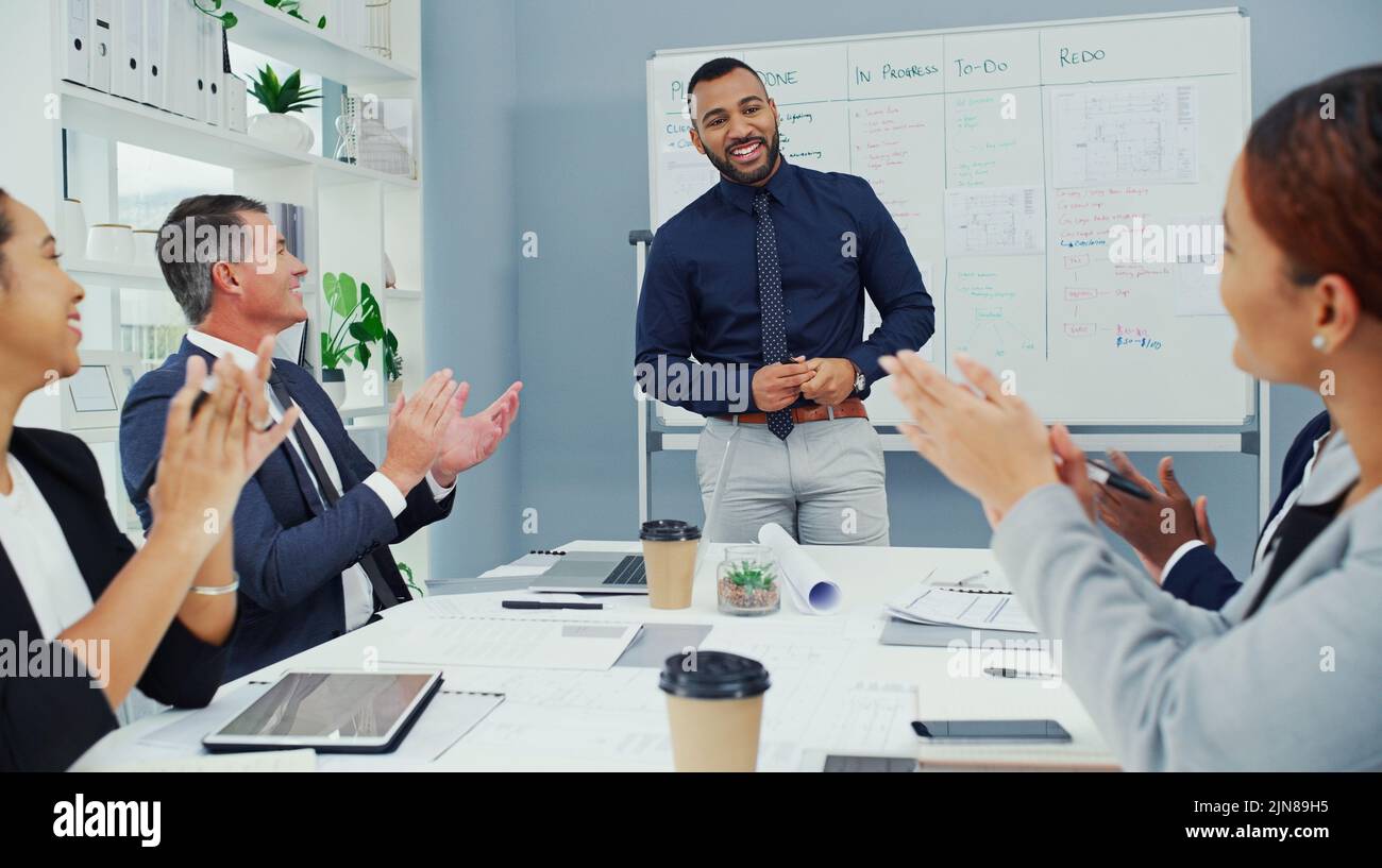 He deserves all the applause and accolades. a young businessman being ...