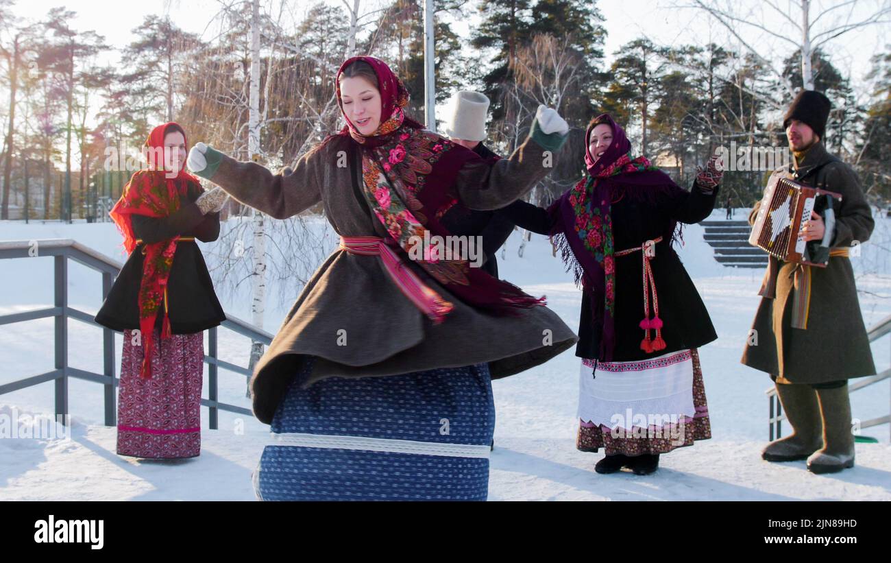 Russian folklore - people in felt boots dancing outdoors at winter time ...