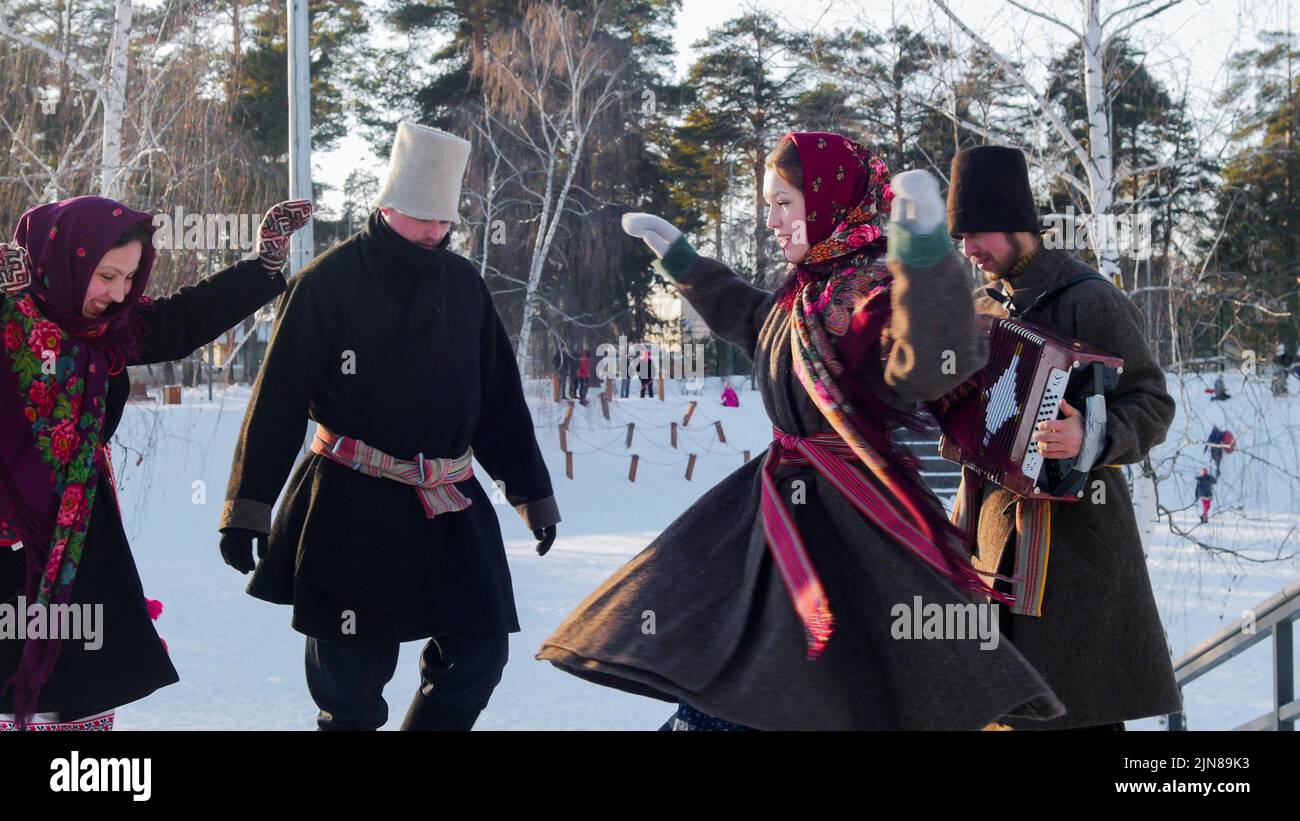 Russian folklore - people in felt boots dancing outdoors at winter time ...