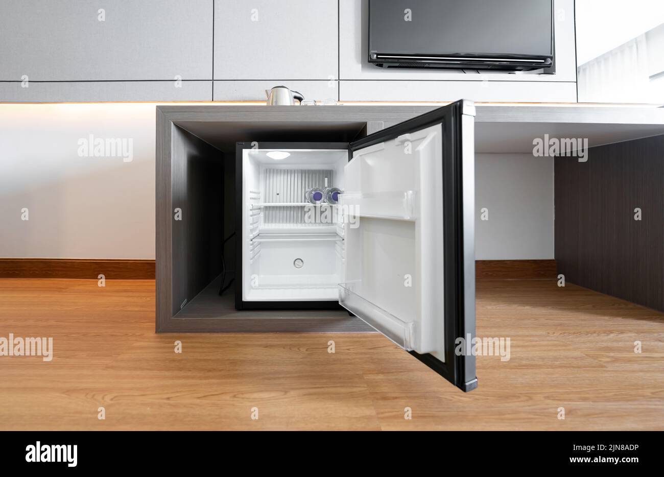 Black mini small fridge refrigerator under the frame wooden counter in ...