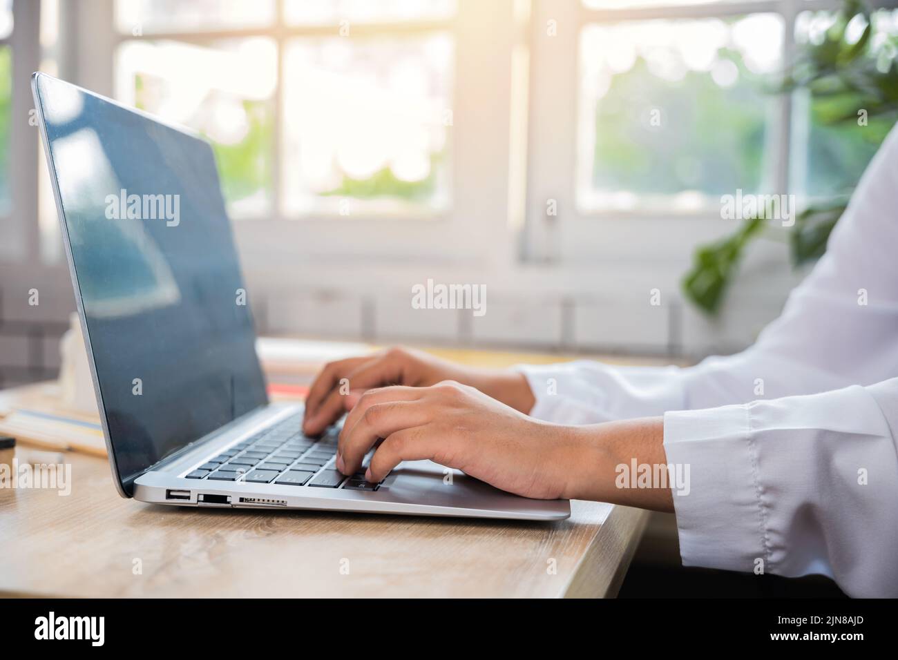 Back to school. Close up hands of female using computer sitting at ...
